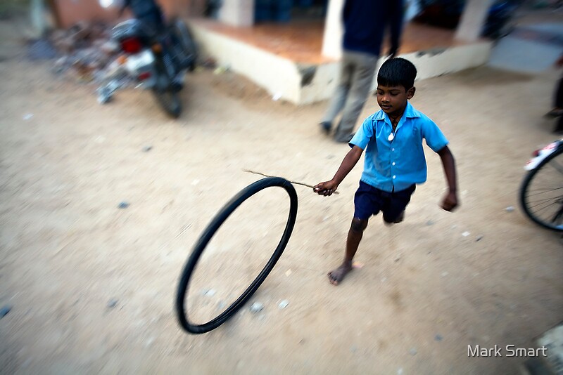"Boy playing with tyre" by Mark Smart | Redbubble