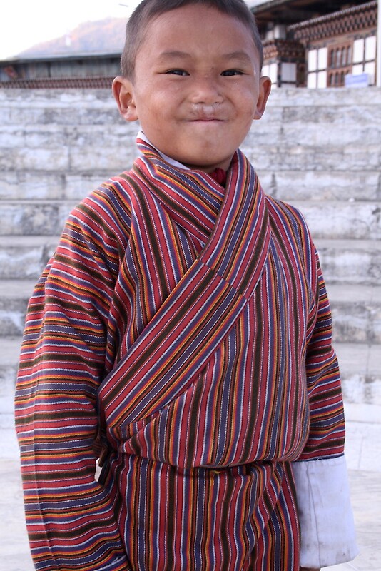 "Young boy wearing a Gho, Paro Bhutan" by LeighBlake | Redbubble