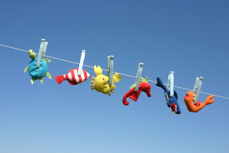 "Colorful sea animal toys hanging on clothesline" by Cebas | Redbubble