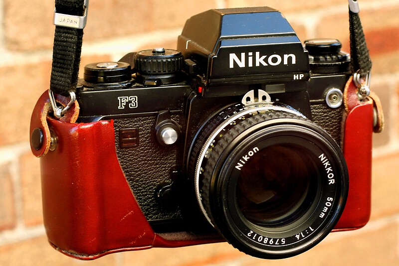 "Nikon F3 HP In Leather Jacket" by Raoul Isidro | Redbubble